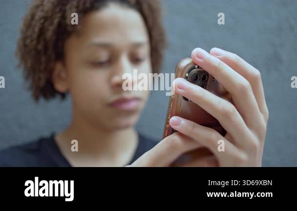 Close-Up Of Teenage Boy Staring At Smartphone With Serious Expression ...
