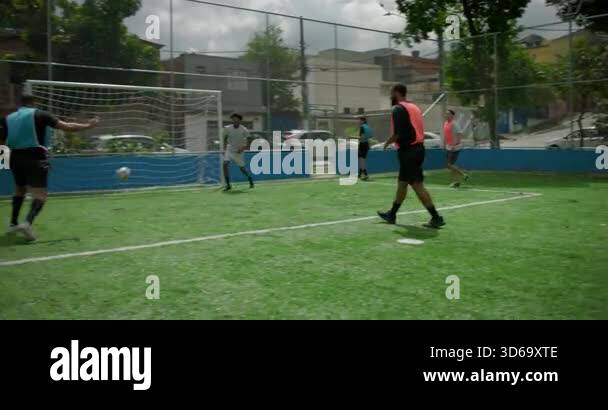 Friends training soccer on neighborhood field, players moving casually ...
