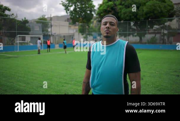 Latin soccer player looking confident on urban field, arms relaxed ...