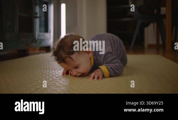 Baby resting face on floor after crawling attempt, showing fatigue and ...