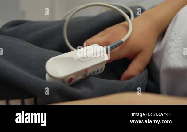 Close-up of childs hand with pulse oximeter sensor in hospital, detail ...