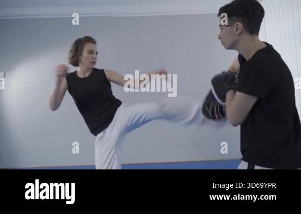 Personal training martial art of taekwondo. Female trainer holding ...