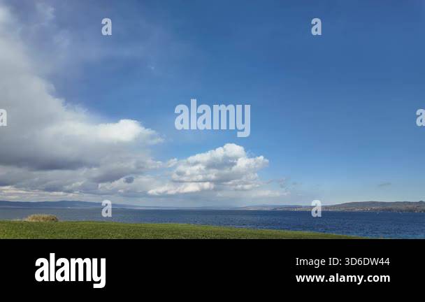 Time-lapse capturing white cumulus clouds drifting across a clear blue ...
