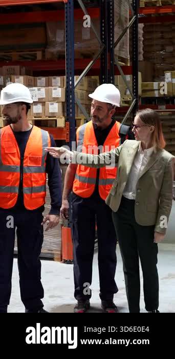 Female supervisor explaining the shipping and receiving process to a ...
