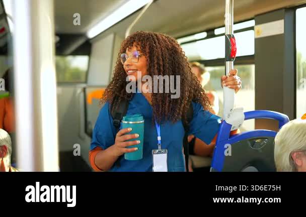 Beautiful african american nurse with curly hair and glasses smiling at ...