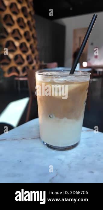 Enjoy a delicious iced coffee in a modern cafe with unique decor Stock ...