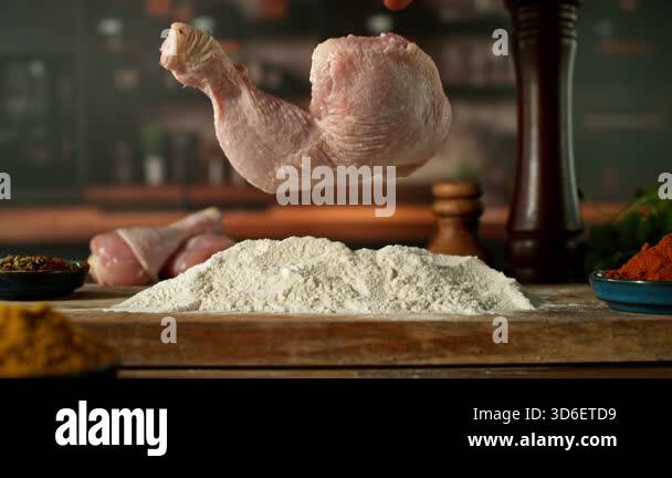 Super Slow Motion of Chef Throwing Raw Chicken Legs into Flour. Filmed ...