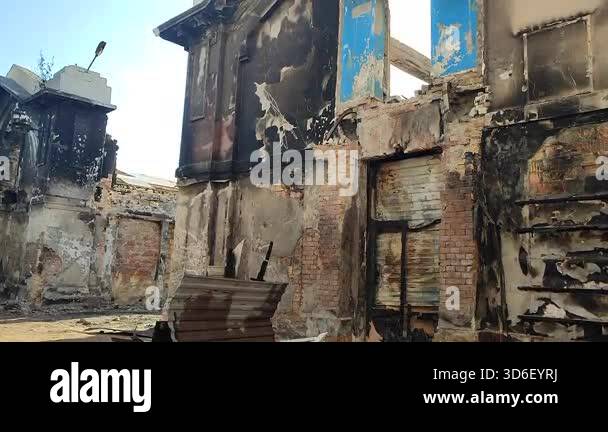 Black charred walls of building after missile hit, explosion, and fire ...