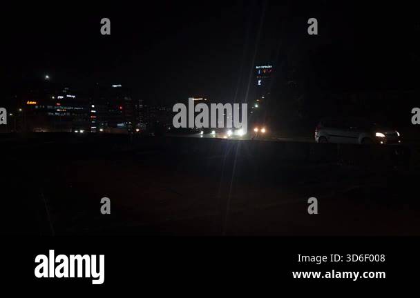 Pune India City Street at Night A dark urban street illuminated by car ...