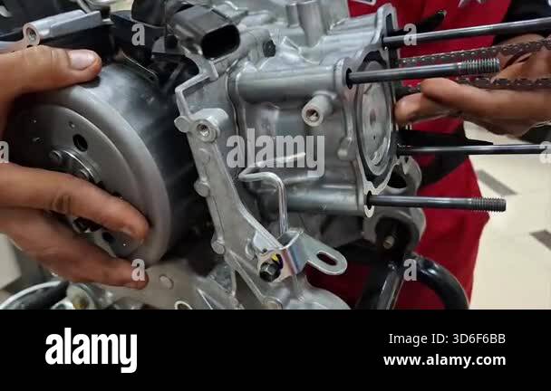 Mechanic Assembling Motorcycle Engine and Educational Cutaway Model ...