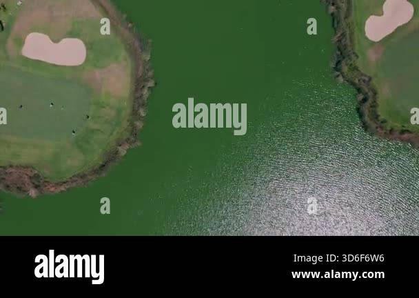 Aerial top-down view of golf course with green fairways and sand ...