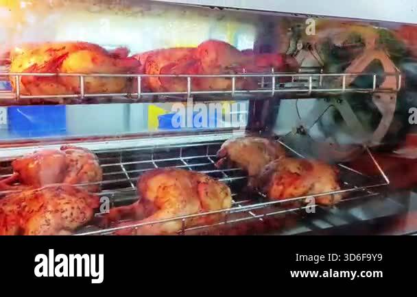 Chicken being roasted using an automatic rolling roaster. This machine ...