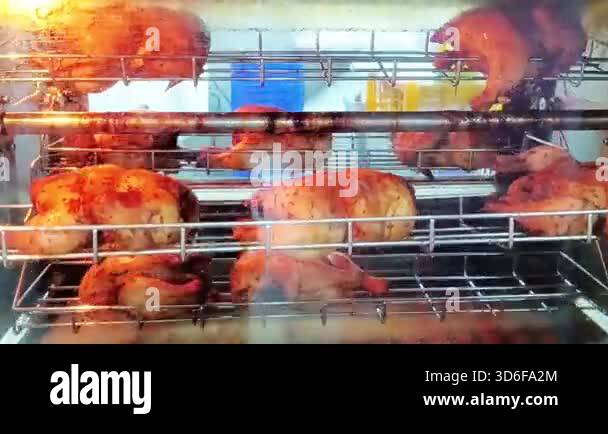 Chicken being roasted using an automatic rolling roasting machine Stock ...