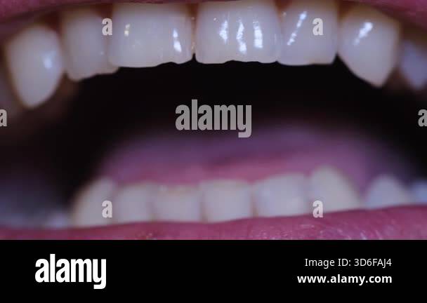 Close-up macro footage showing teeth and lips in detail. Concept of dental health and oral ...