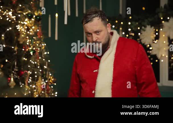 Santa Claus looks weary and thoughtful after a busy holiday, sitting ...