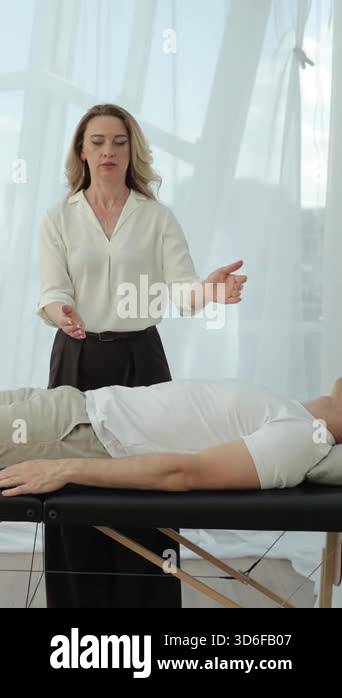 A practitioner performs an Access Bars session, gently touching head ...