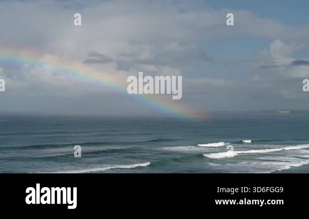 Rainbow stretching over the Atlantic Ocean above sandy beach in Santa ...