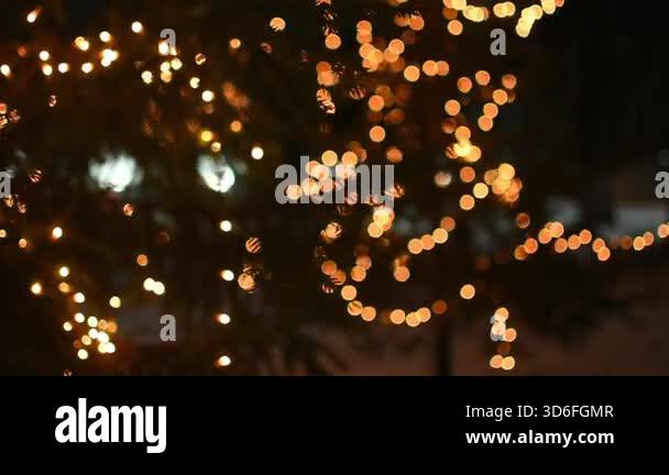 Christmas lights glowing softly in darkness, creating warm golden bokeh ...
