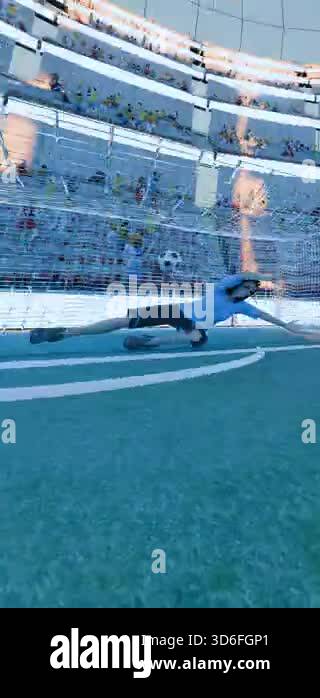 Female soccer goalkeeper diving to save goal during match in stadium ...
