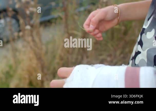 closeup bandaged wrist caucasian teen checking movement on sidewalk ...