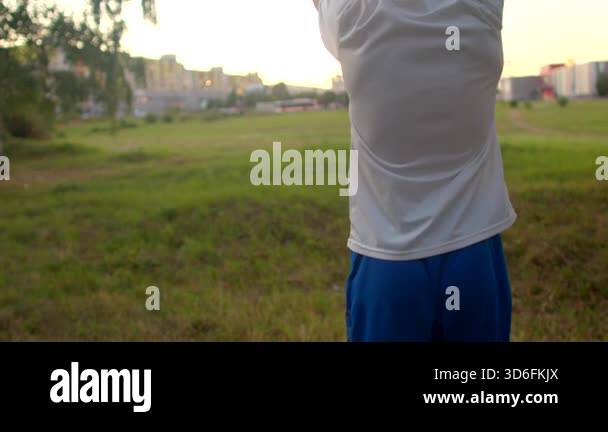 wide caucasian teen back view standing in open field facing distant ...