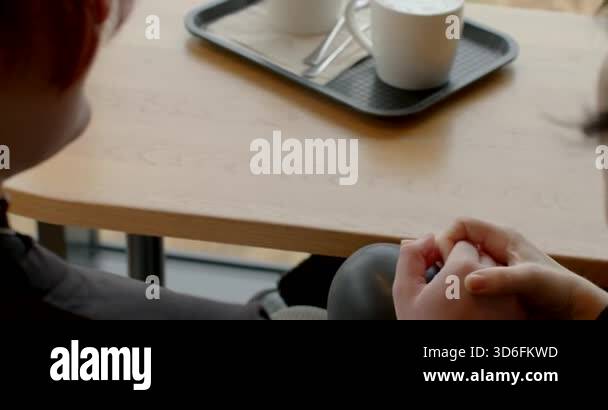 white women cafe hands twined near cups, close-up of fingers clasping ...