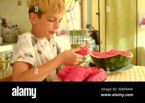 Child enjoys watermelon, Lively scene of young boy exploring and ...