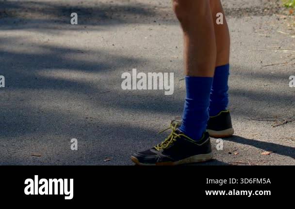 Person bends down to grasp jump rope handles, Individual adjusts jump ...