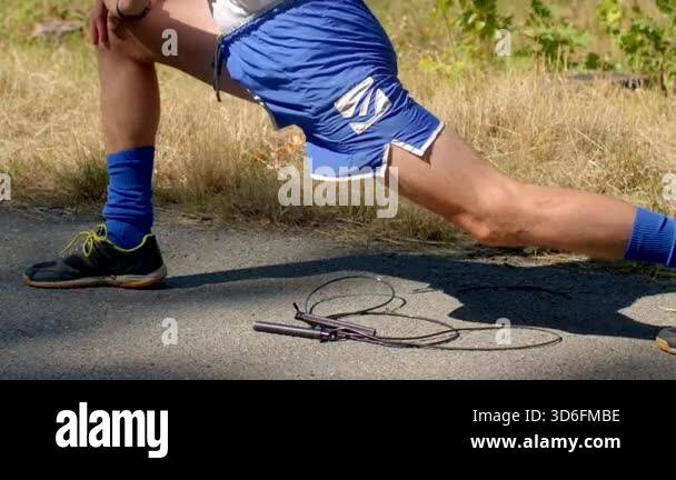 Athlete stretches flexibly, Athlete in blue garments demonstrating ...