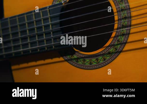 Guitar strings vibrating super slow motion medium shot selective focus ...