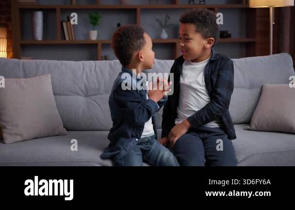 Two little African American boys talking fighting playing at home on ...