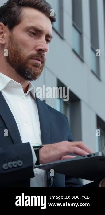 Serious focused Caucasian mature business man with laptop in city ...