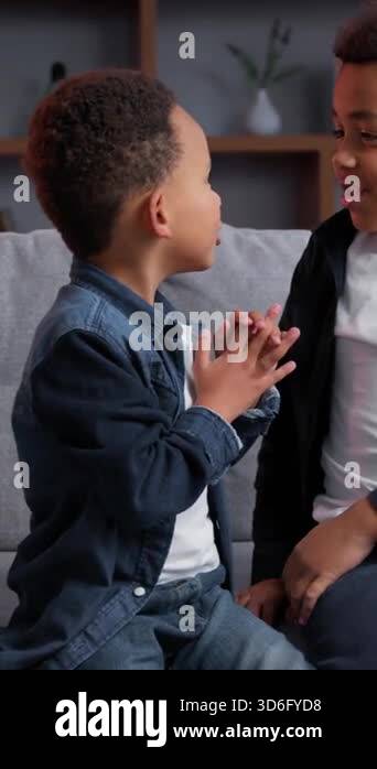 Two little African American boys talking fighting playing at home on ...