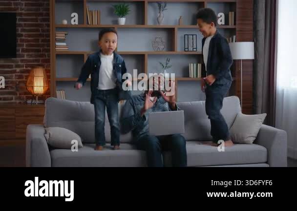 African American family father working at home noisy sons distract busy ...