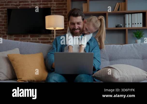 Happy Caucasian family at home cute daughter hugging father working ...