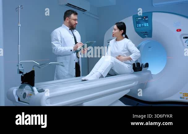Doctor talking to patient before undergoing MRI. Patient explaining ...