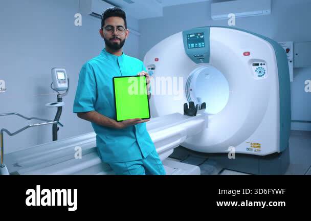 Indian tomography specialist showing tablet with chroma key screen ...