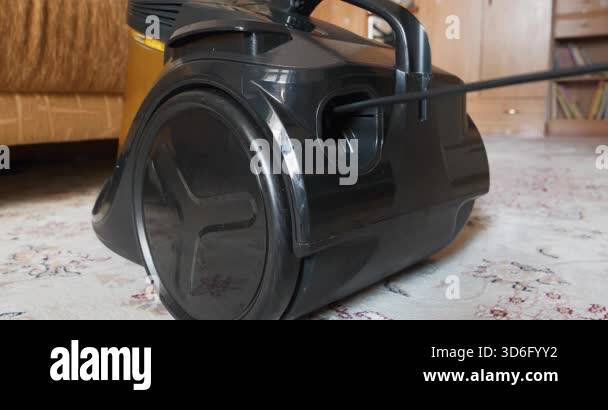Man pulls an electrical cord out of vacuum cleaner. Vacuum cleaner cord ...