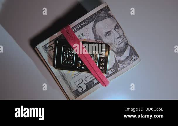 Gold bar on us dollar bills representing wealth Stock Video Footage - Alamy