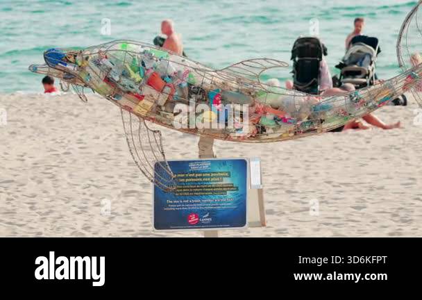 Cannes, France - October 4, 2025: Metal dolphin sculpture filled with ...