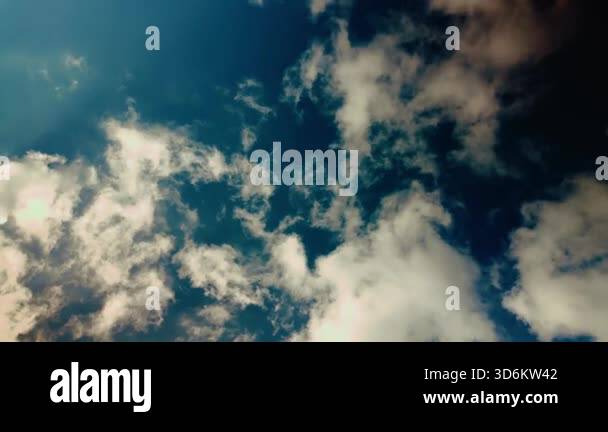 A dynamic, low-angle shot looking straight up at a deep blue sky with ...