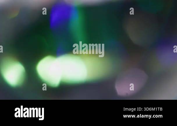 Optical glare. Bokeh beam. Defocused yellow green orange colorful ...