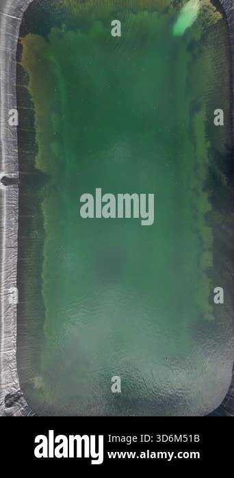 High-angle aerial view of a large artificial water basin for ...