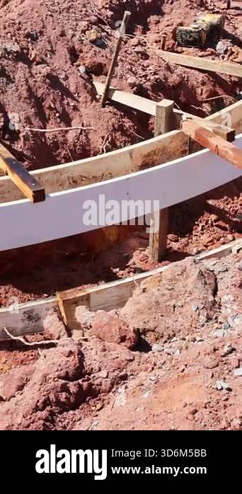 Set up wooden forms in preparation for pouring concrete at construction ...
