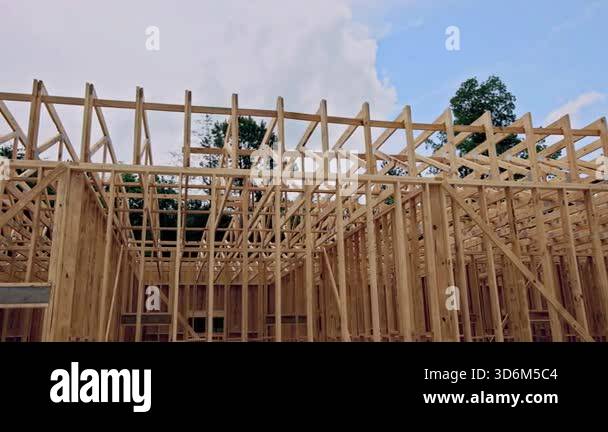 Construction workers build new house using wooden beams trusses in ...