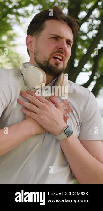 Young adult sports man runner jogger having heart attack or chest pain ...