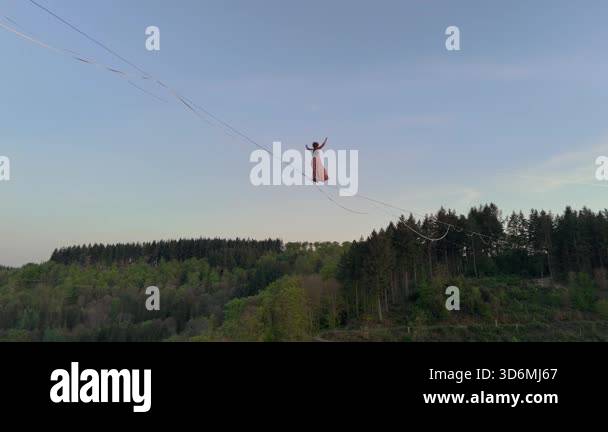 Highline Aerial Shot. The Tightrope Walker is on a rope stretched ...