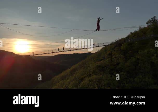 Highline Aerial Shot. The Tightrope Walker is on a rope stretched ...