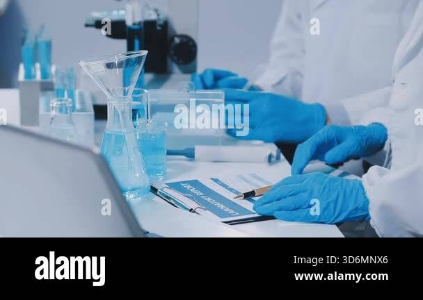 scientist holding tube with test tube and chemical sample on laboratory ...