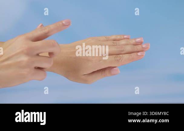 Finger applying moisturizing cream to hand, showing smooth skin and a ...